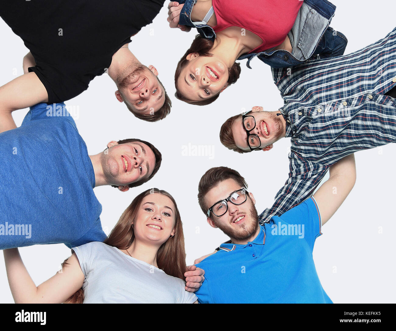 portrait of confident college students forming huddle over white ...