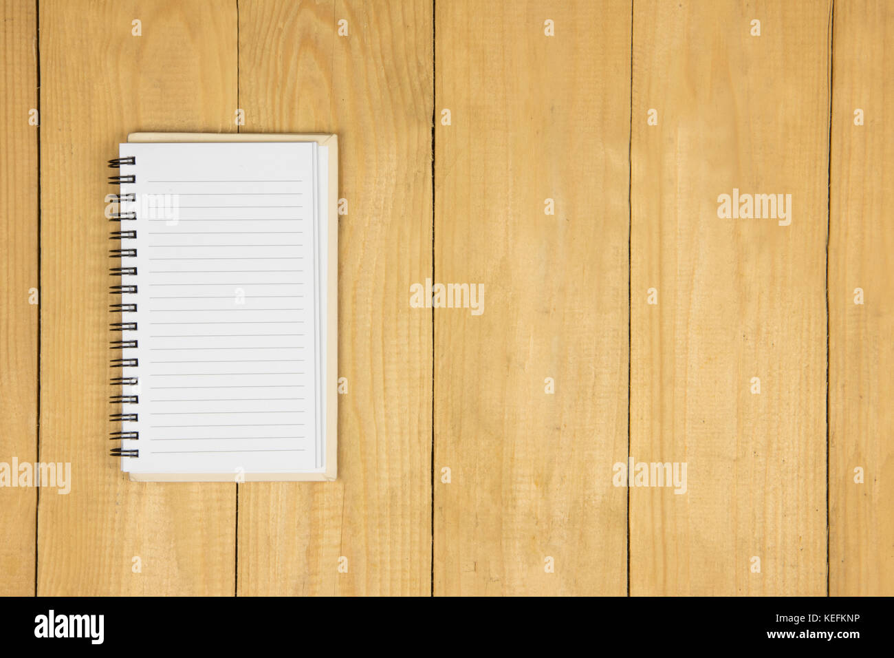 Notebook on hardwood, top angle view, copy space Stock Photo - Alamy