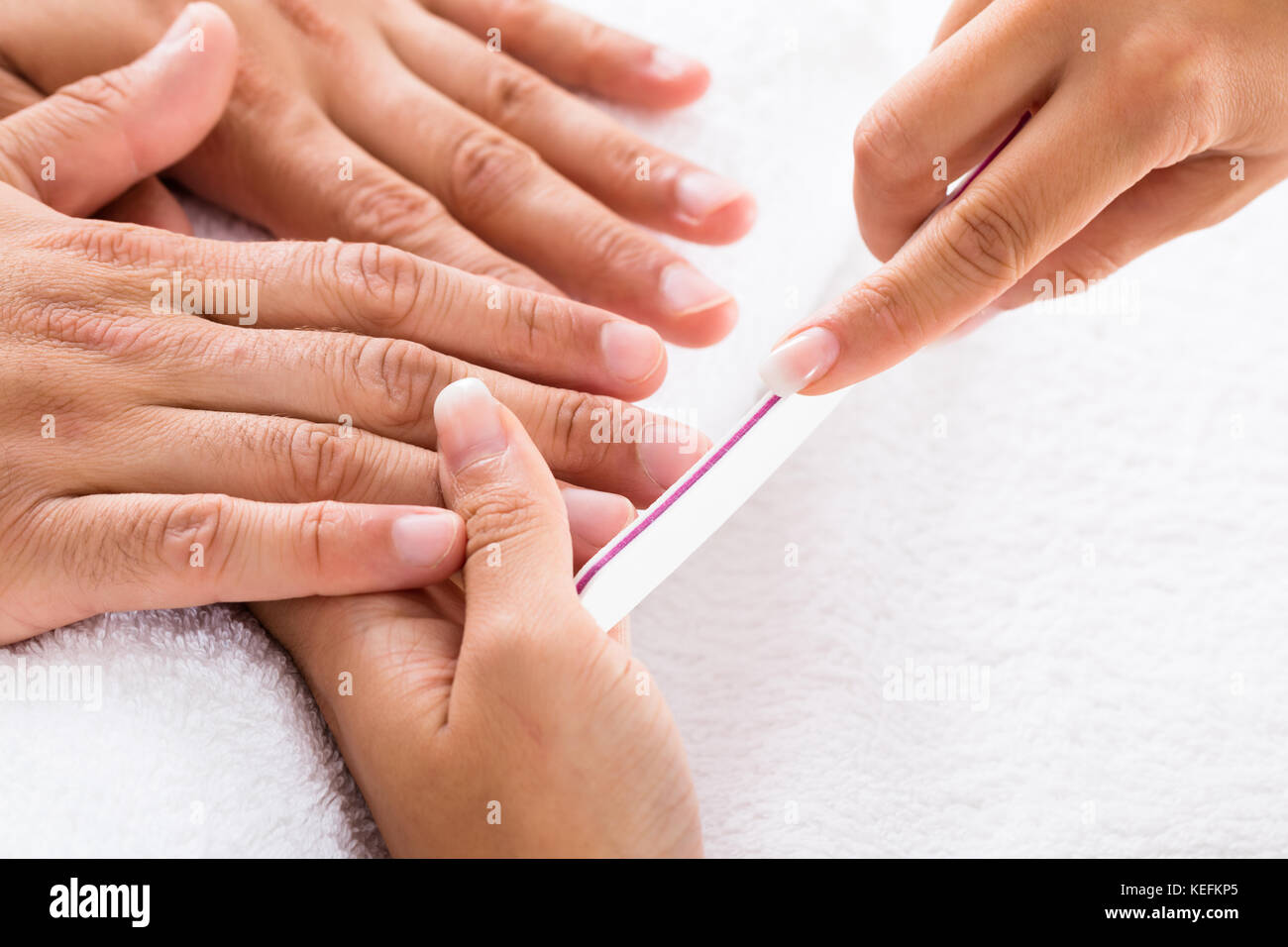 Close-up Of A Manicurist Filing Person's Nails In Salon Stock Photo - Alamy
