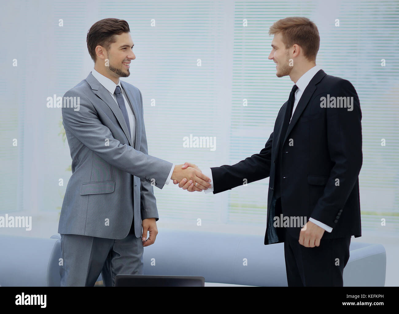 Business meeting at the table with handshake Stock Photo - Alamy