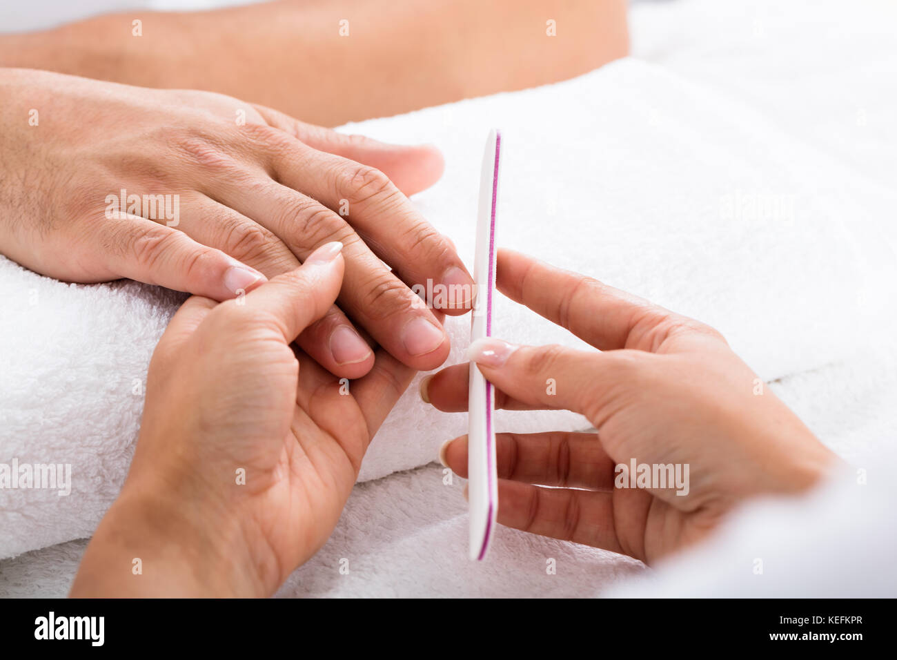 Close-up Of A Manicurist Filing Person's Nails In Salon Stock Photo - Alamy