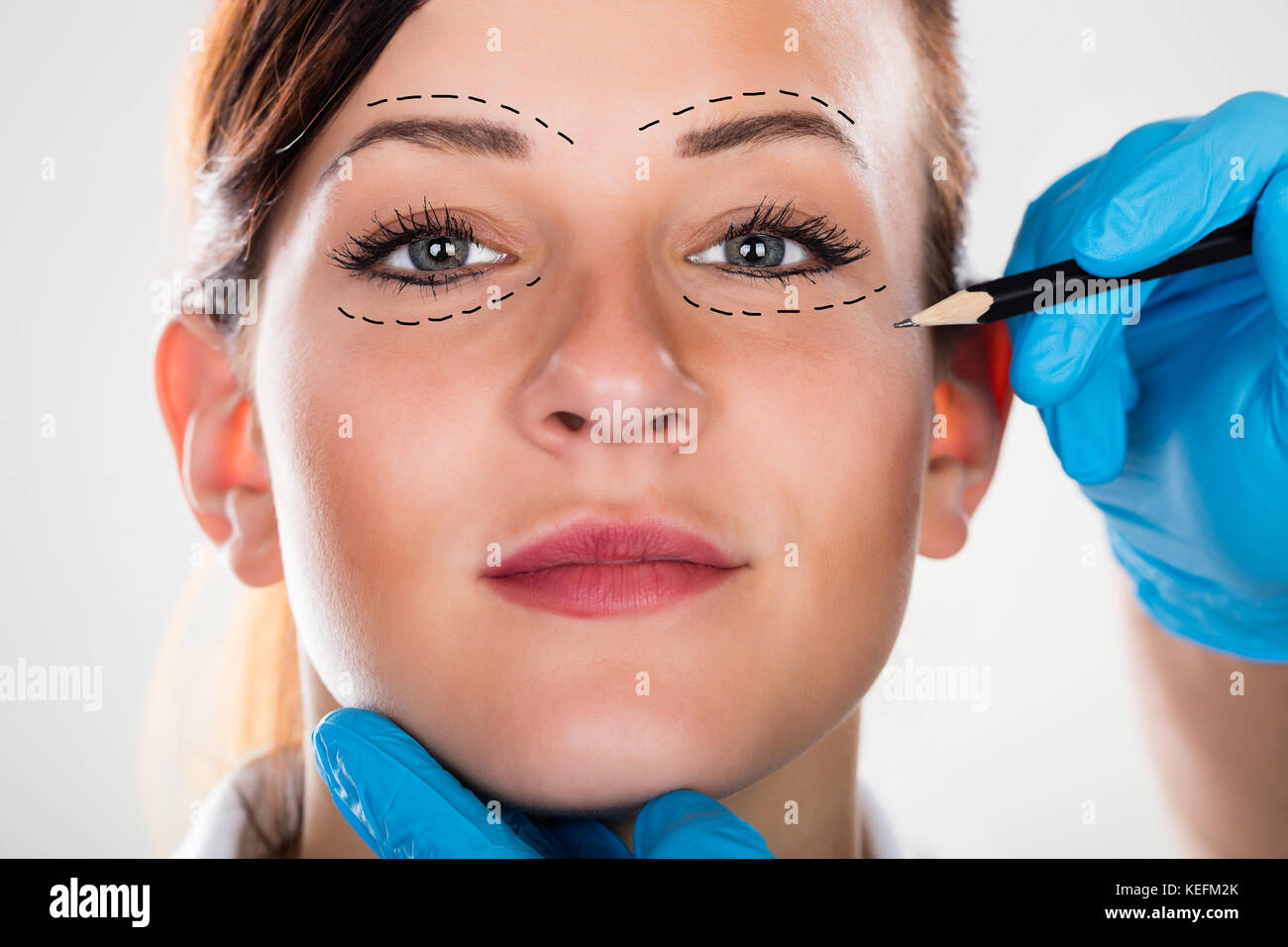 Hand dermatologist touching face hi-res stock photography and images ...