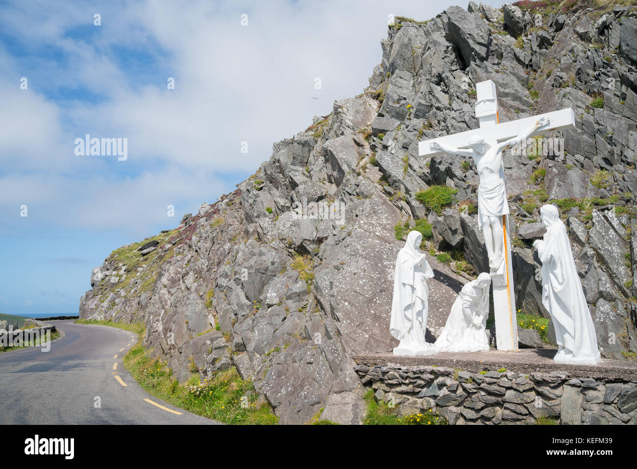 Christ on cross statue on winding Irish West Coast road Stock Photo - Alamy
