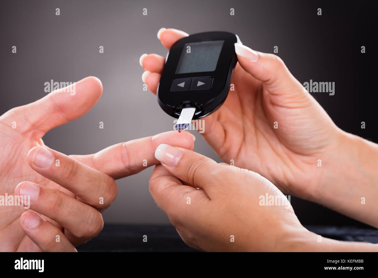 Close-up Of A Doctor Checking Patient's Sugar Level With Glucometer ...