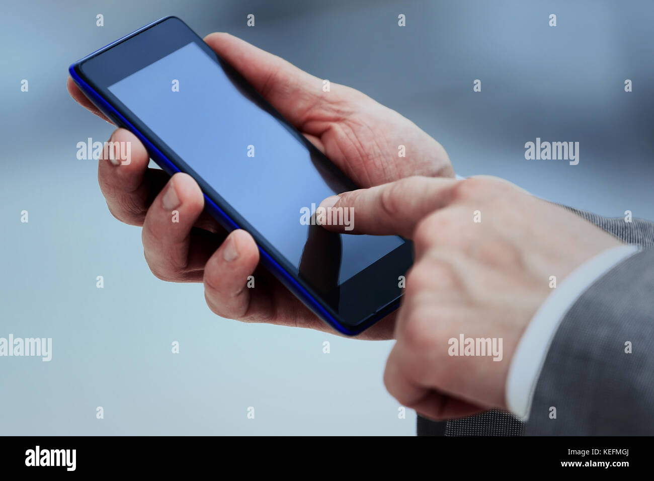 young man pointing at smartphone virtual screen. Internet concept ...