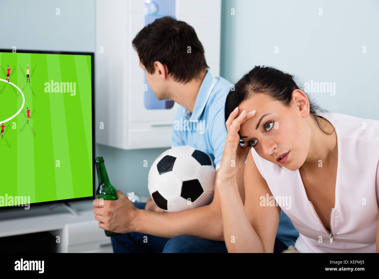 Depressed man watching tv hi-res stock photography and images - Alamy