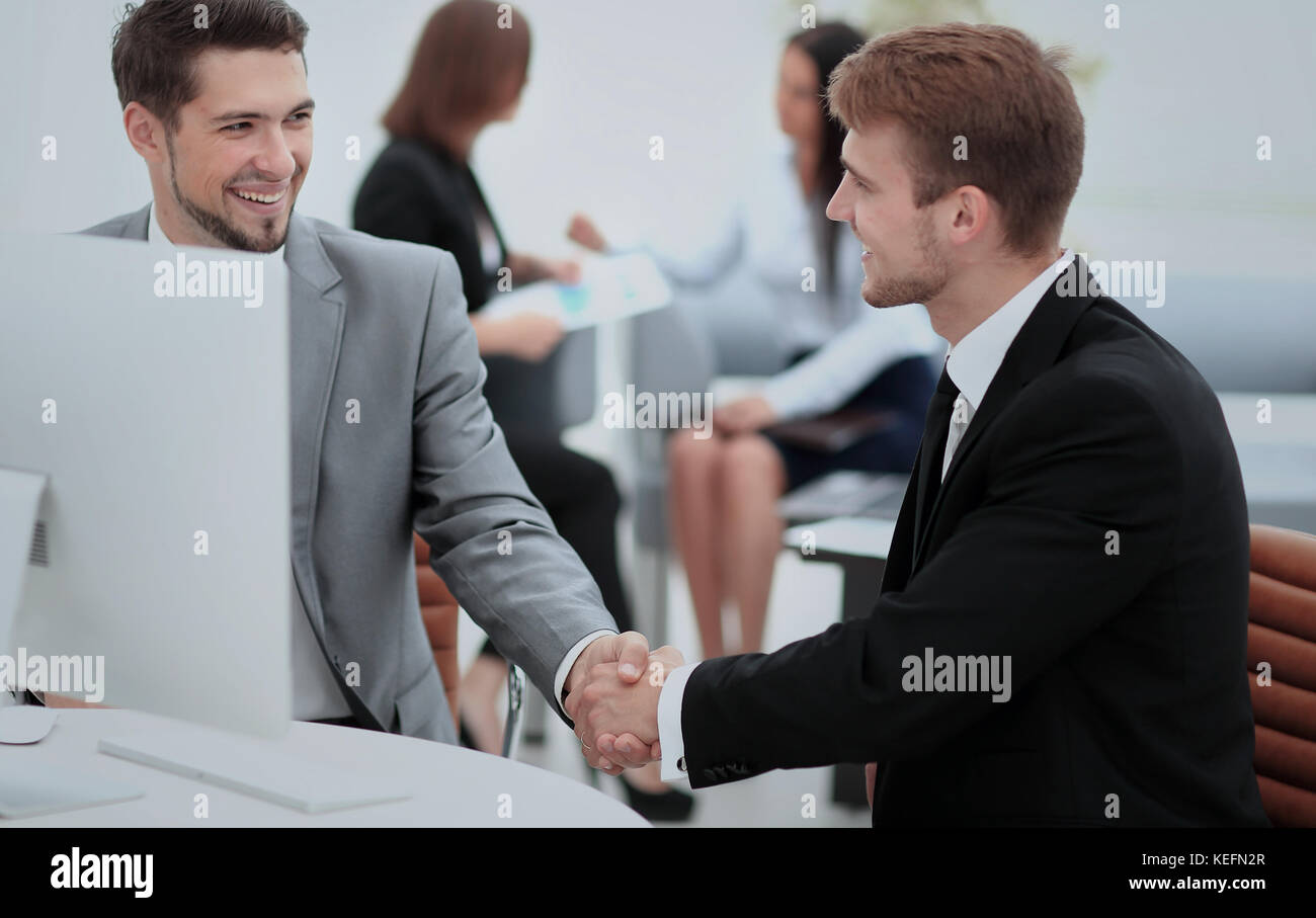 Happy smiling business man shaking hands after a deal in office Stock ...