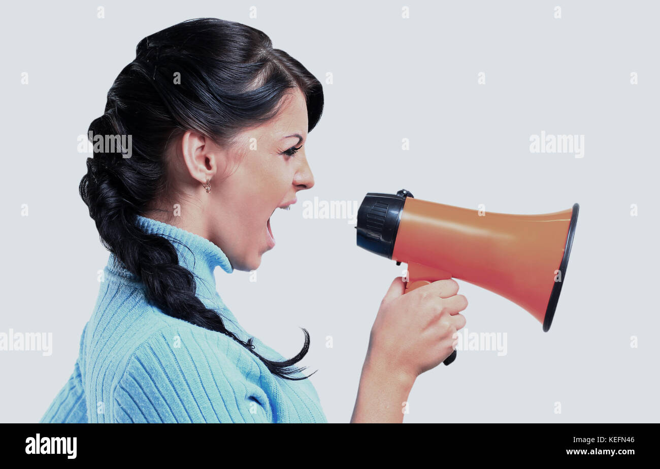 young woman speaking through megaphone Stock Photo - Alamy