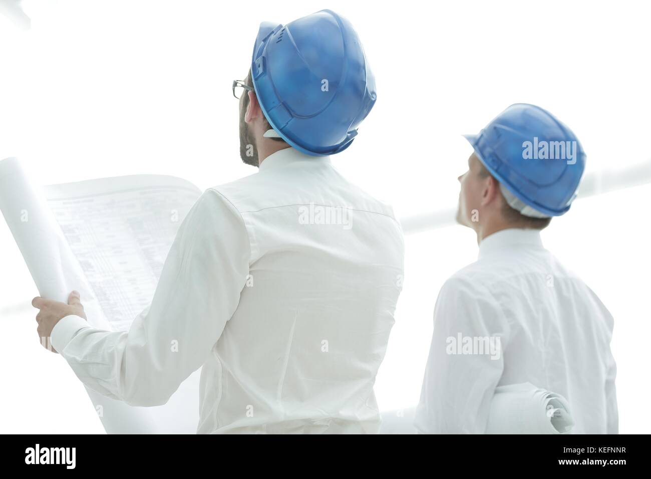 rear view.architect and Builder looking at blank screen Stock Photo - Alamy
