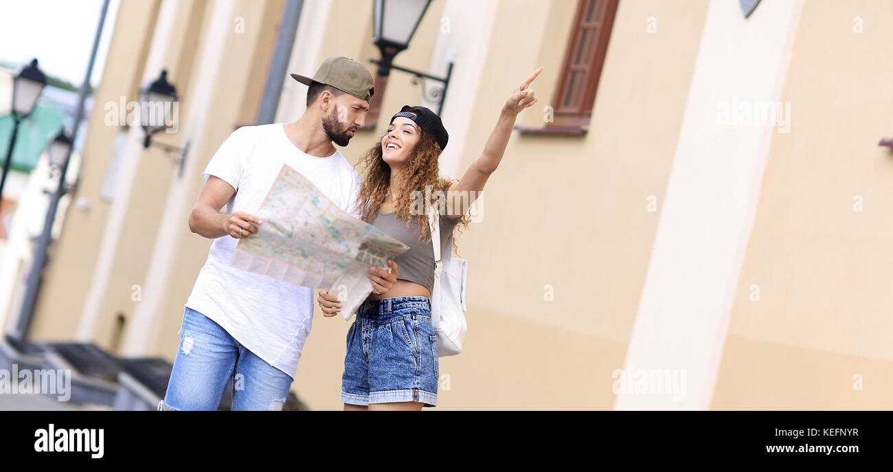 Young tourist couple with map looking for a way Stock Photo - Alamy