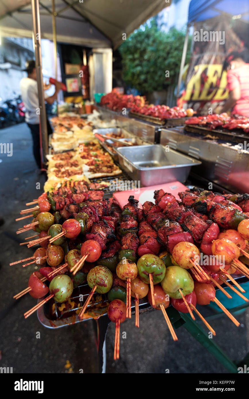 Close up up of chicken cube and roasted vegetables on kebab skewers ...