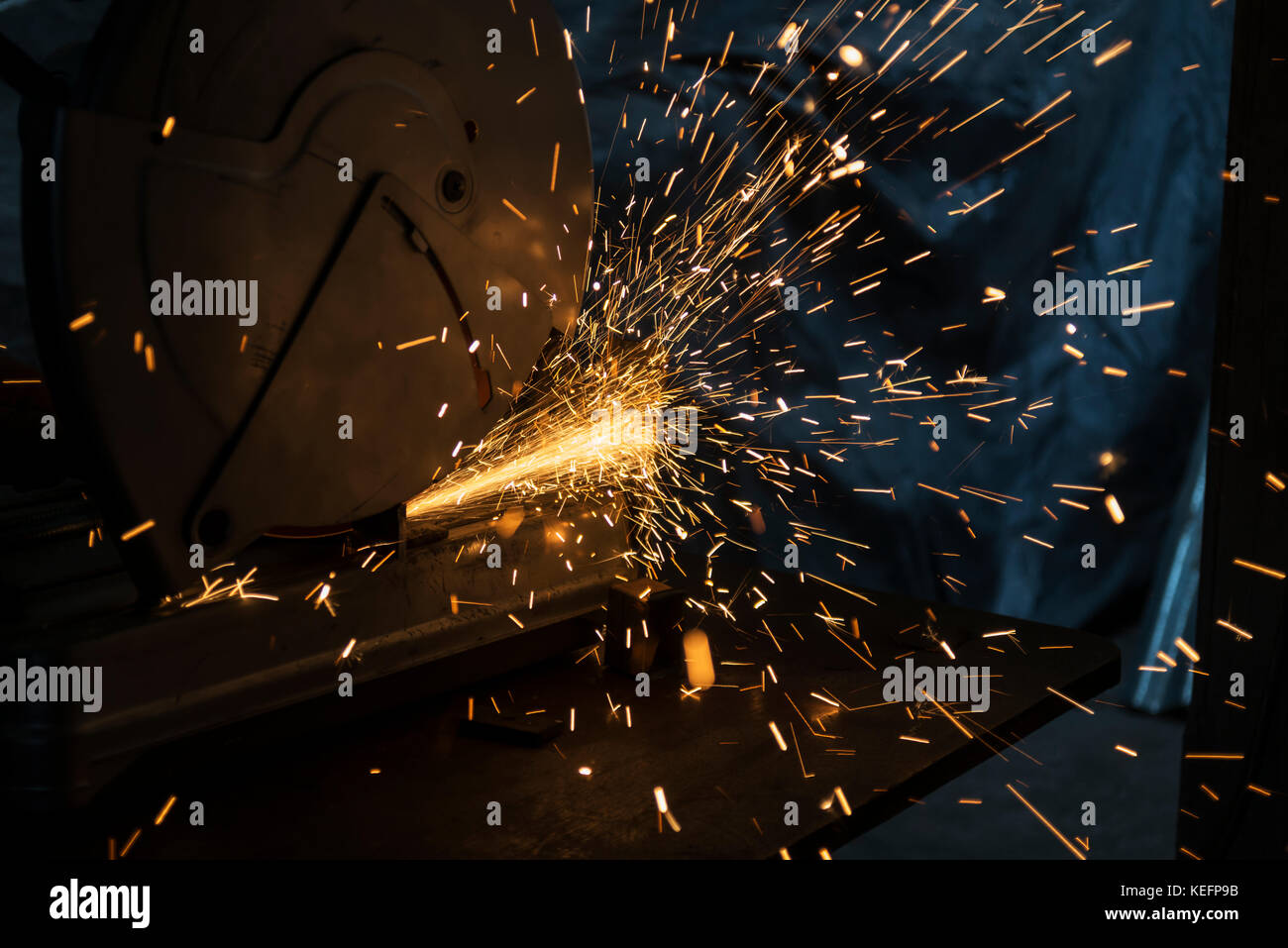 worker cutting iron plate with grinder in old metal workshop Stock ...