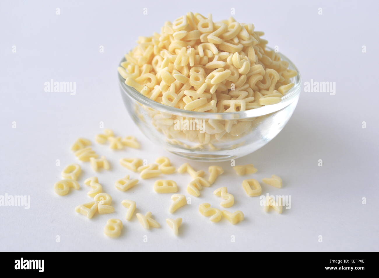 Alphabet pasta for children's meals. ABC pasta. Dry pasta in a glass ...