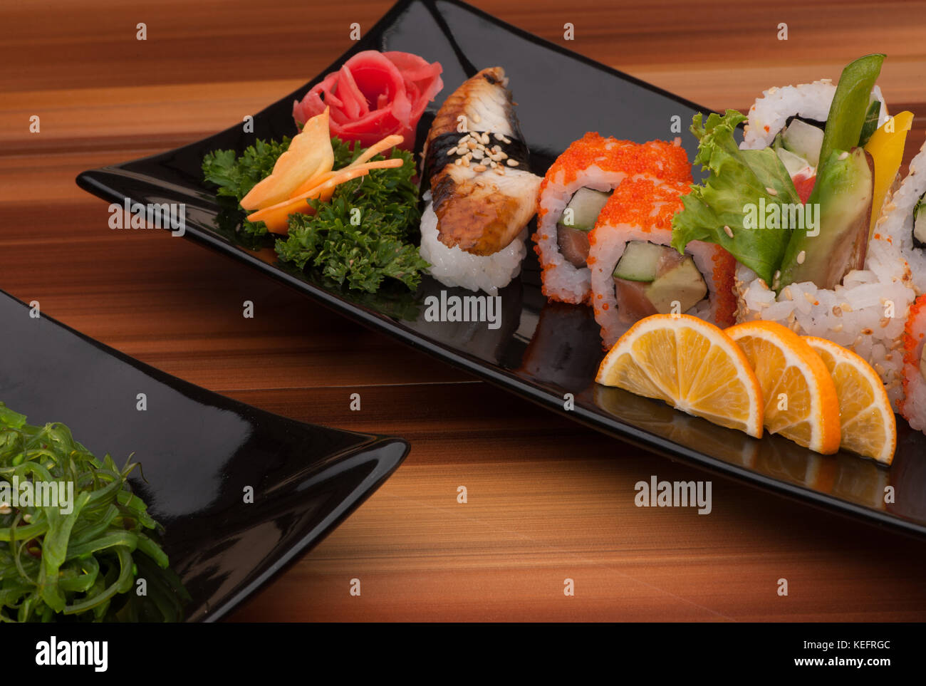 assortment of sushi in black square plate Stock Photo - Alamy