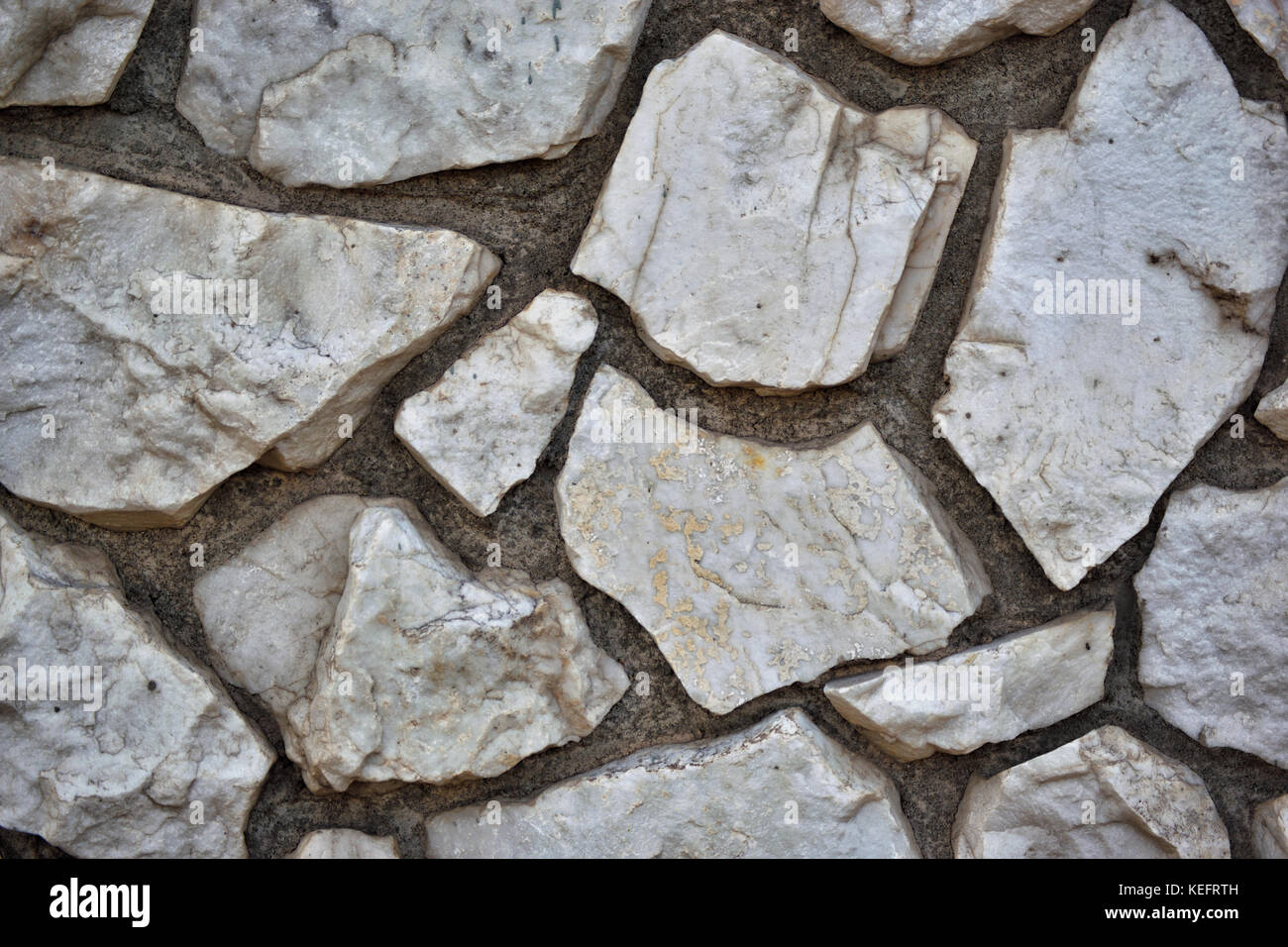 Close view of a quartz stone construction wall Stock Photo - Alamy