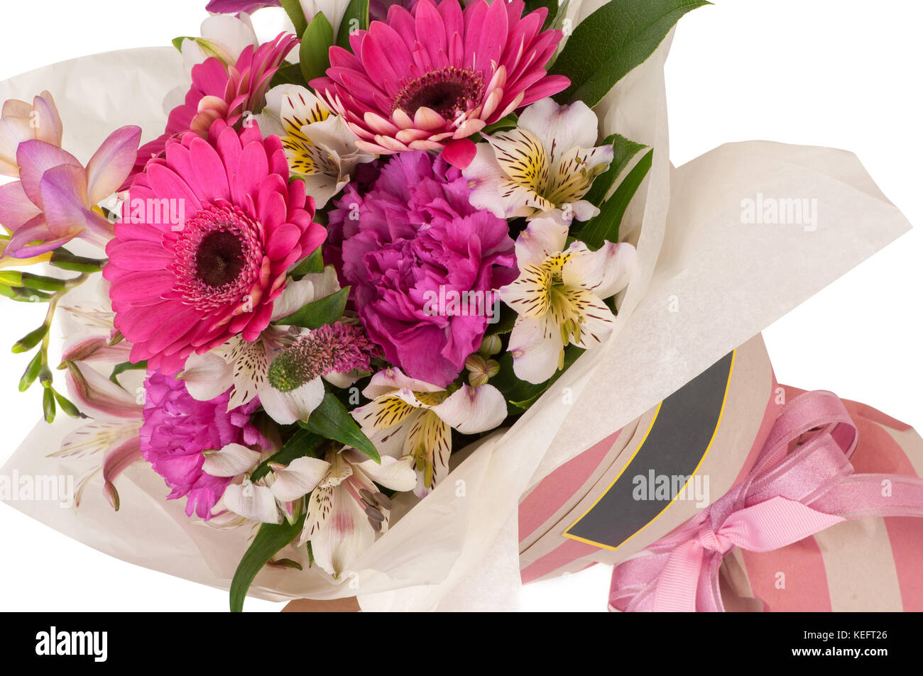 carnation and gerbera in a paper bouquet tied ribbon on a white ...