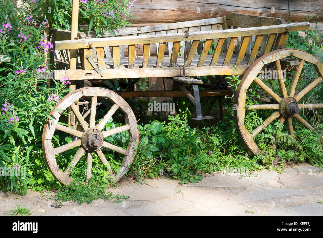 Beautiful old rustic retro wooden cart in house garden Stock Photo - Alamy