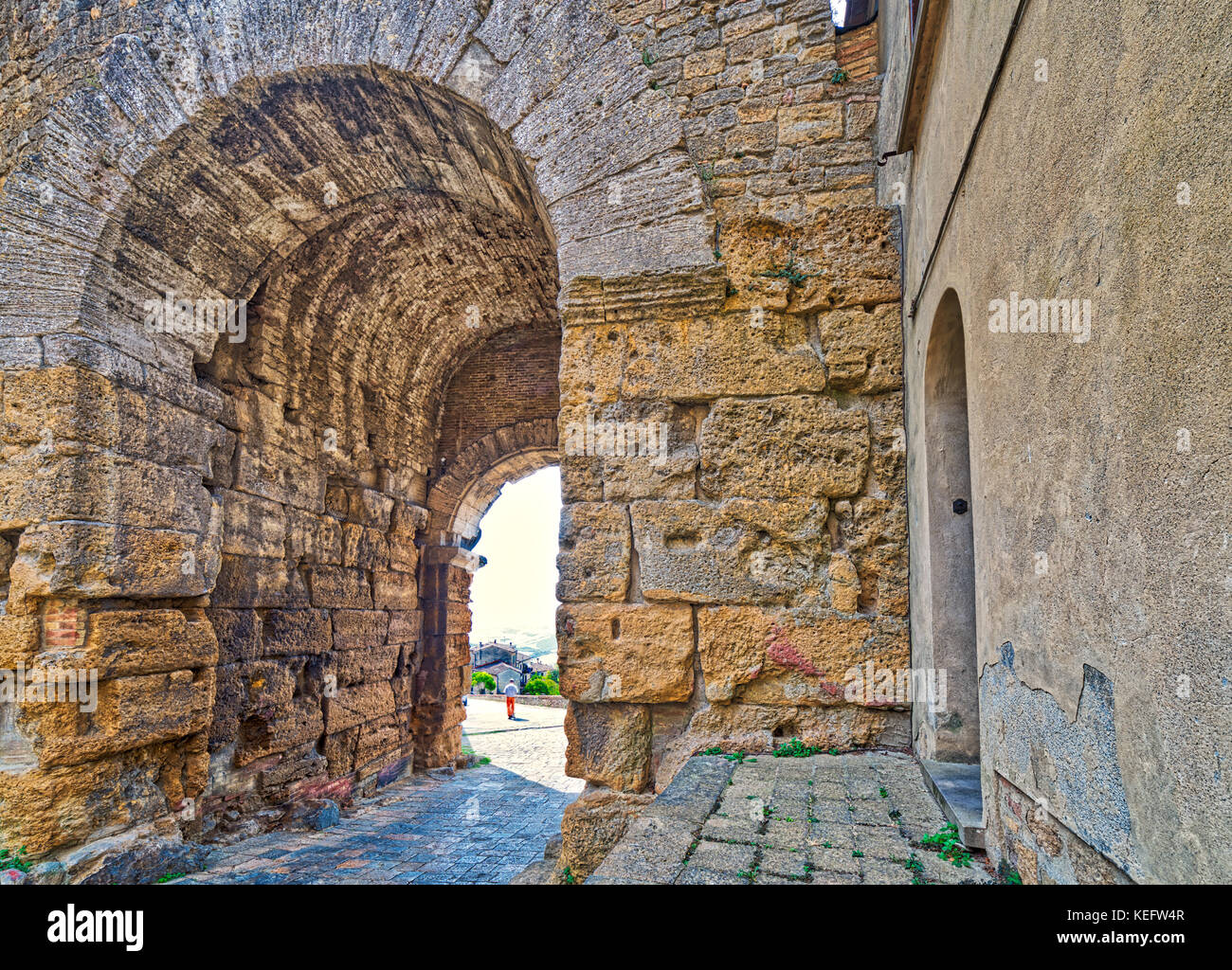 stone arch in street of Volterra, Italy Stock Photo - Alamy