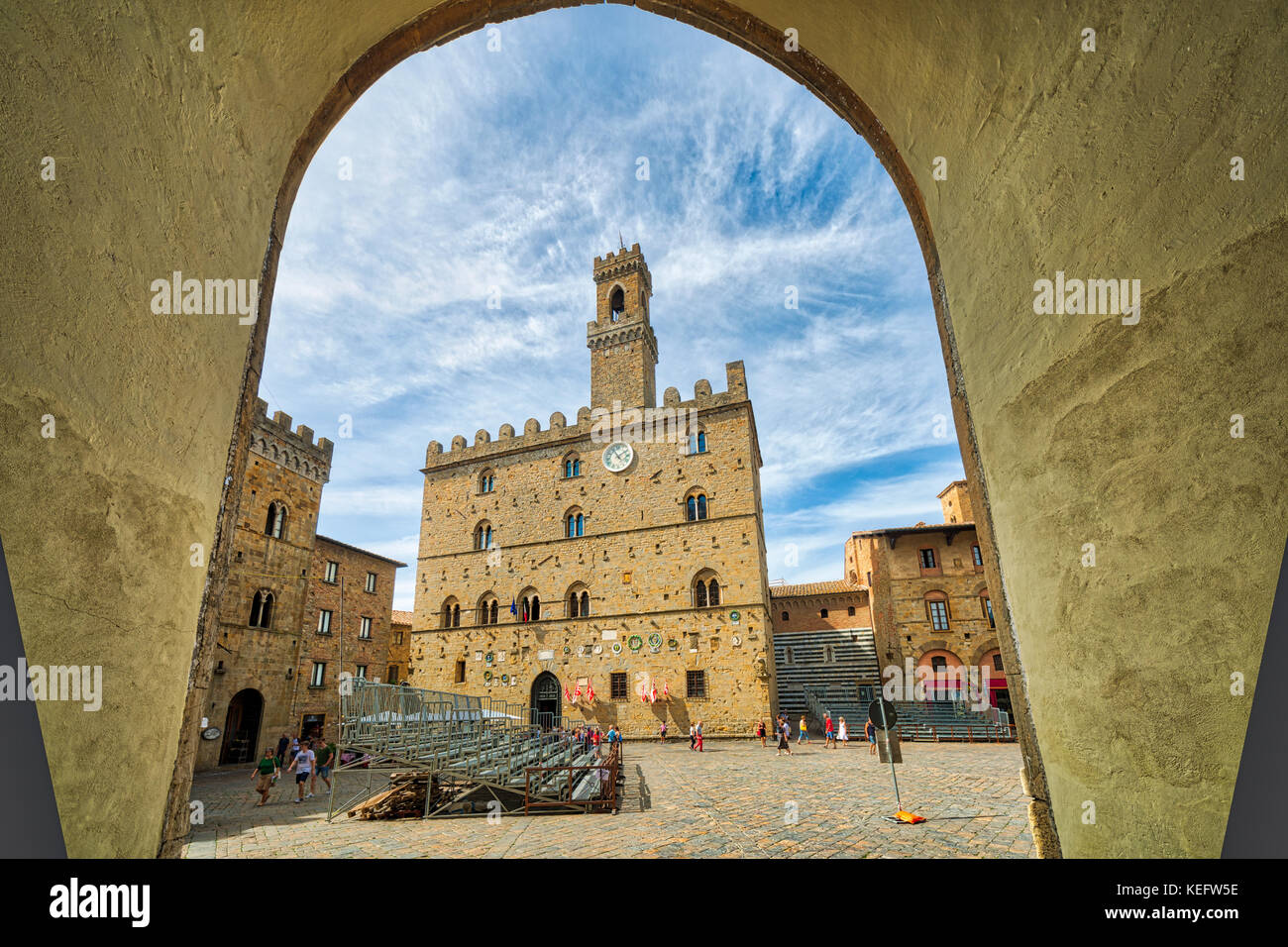 arch to ancient buildings in the main square of Volterra, Italy Stock ...
