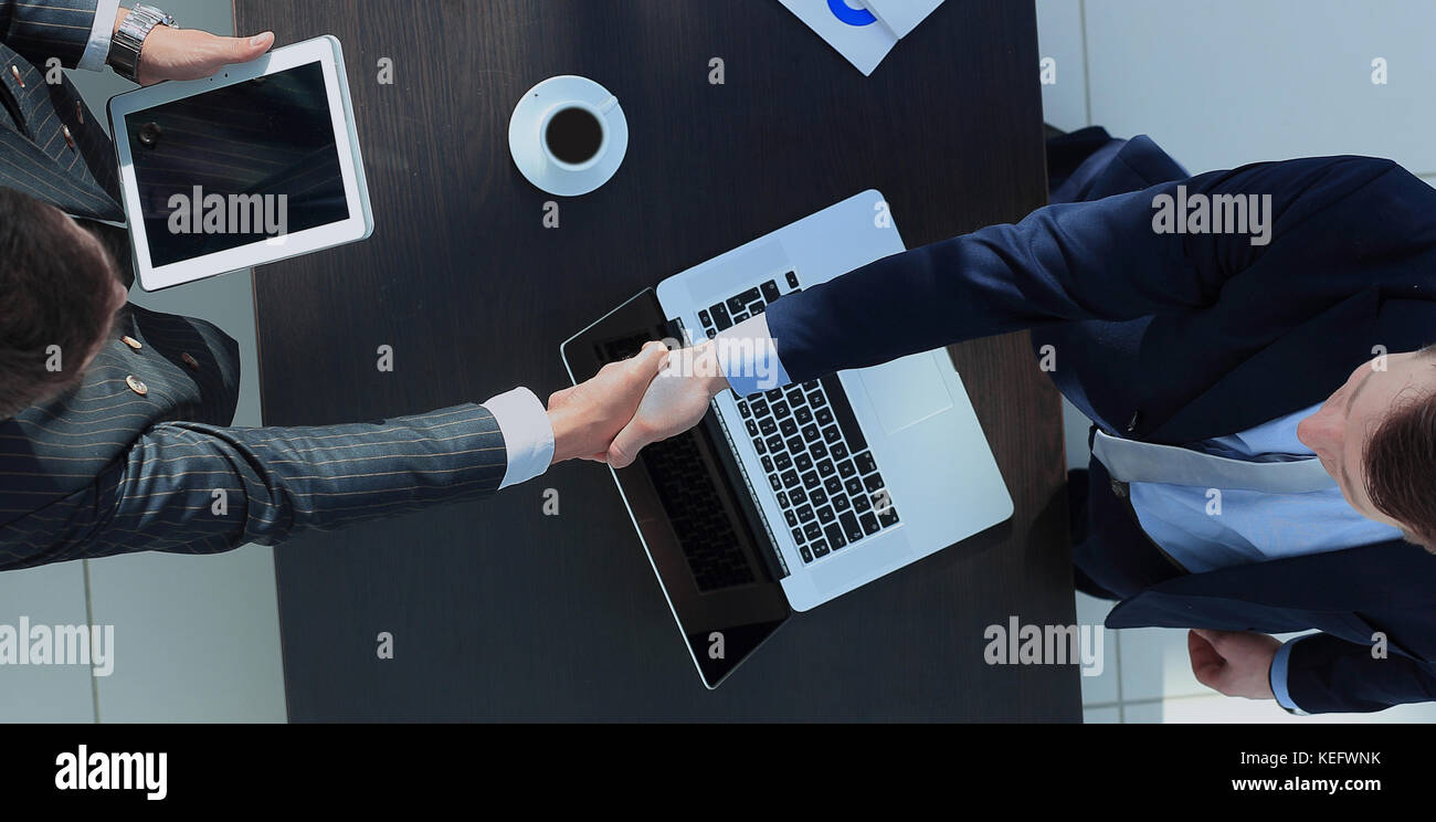 Businessmen shaking hands. Top View Stock Photo - Alamy