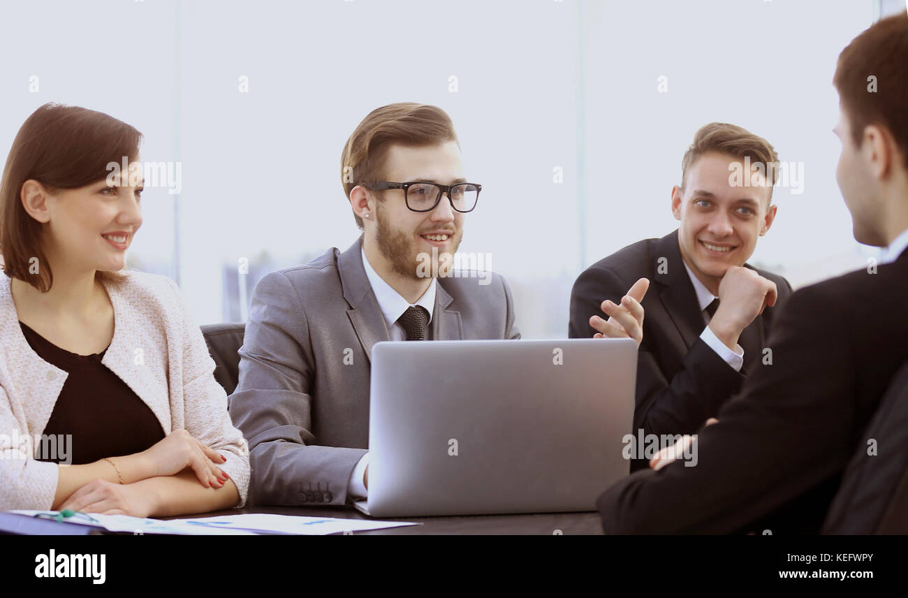 close-up of a company accountant, sitting at a Desk before an open ...