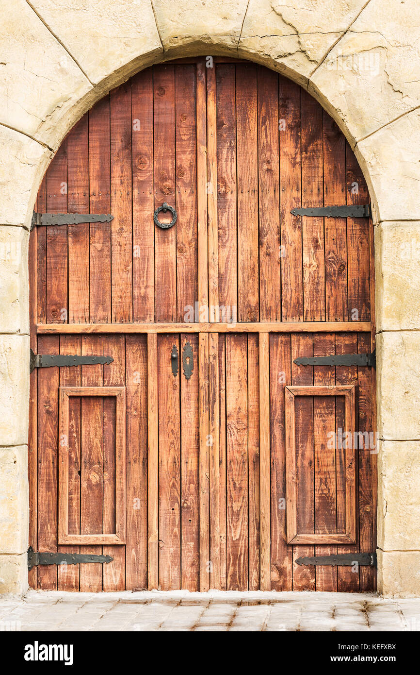 rustic and wooden entrance door on stone facade Stock Photo - Alamy