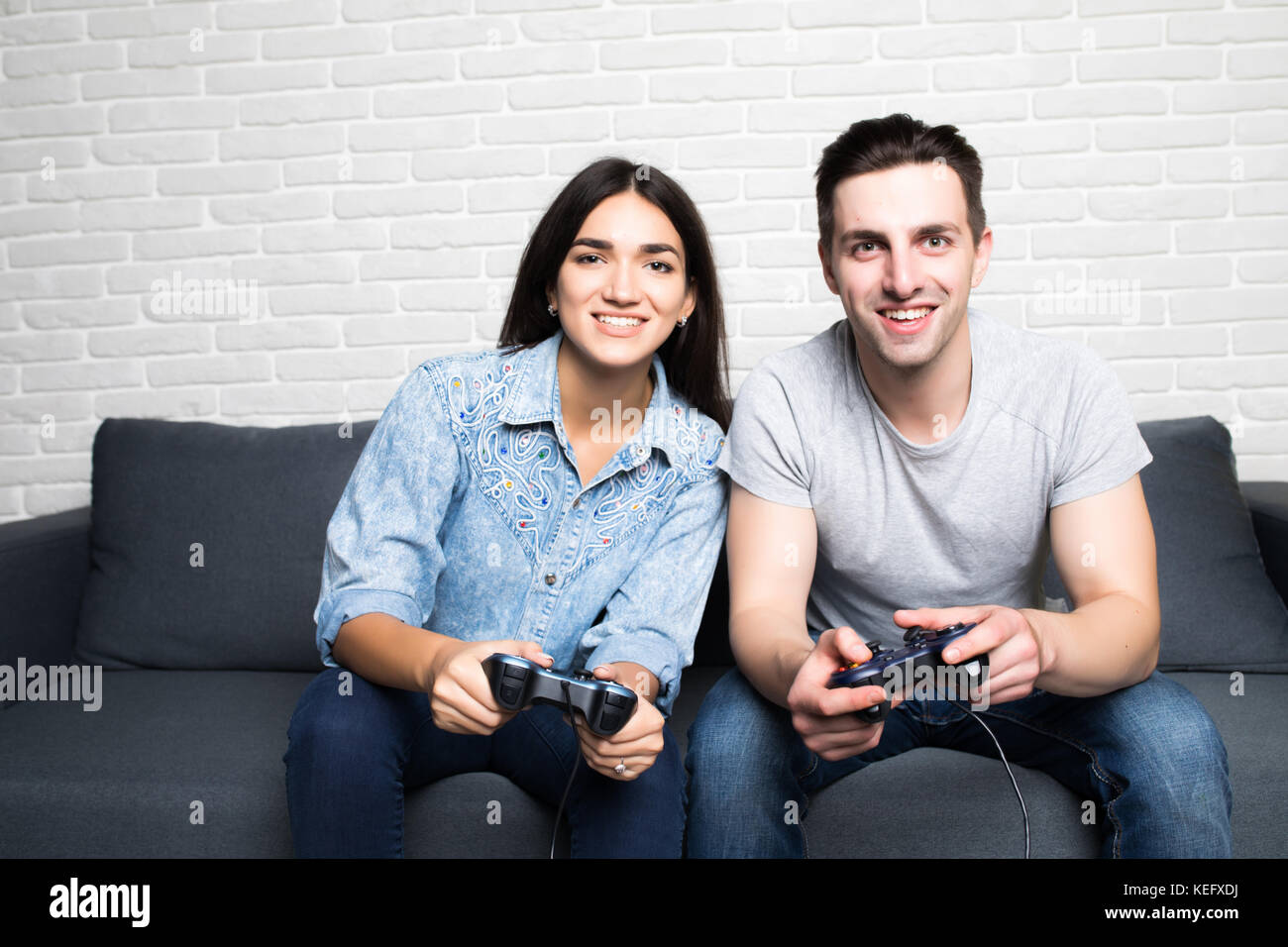 Competition of a siblings playing car race. Excited friends are playing ...
