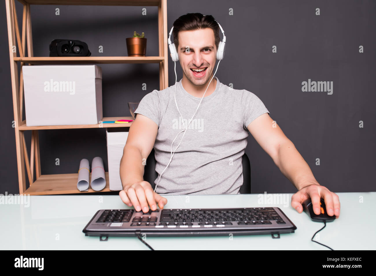 angry screaming young man in headset with pc computer playing game at ...