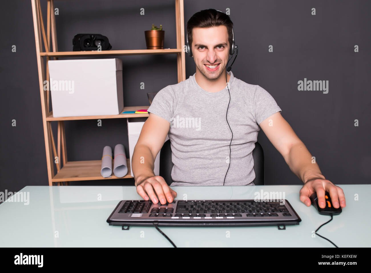 angry screaming young man in headset with pc computer playing game at ...