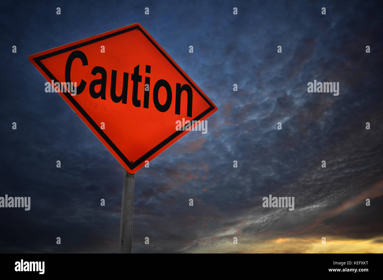 Caution warning road sign with storm background Stock Photo - Alamy