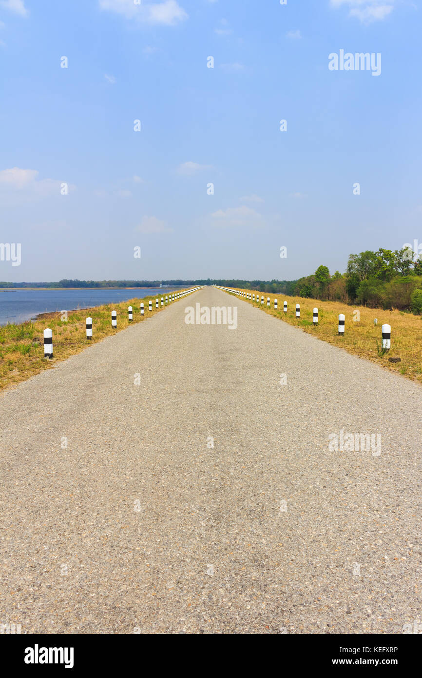 Road over a dike along a lake in summer Stock Photo - Alamy