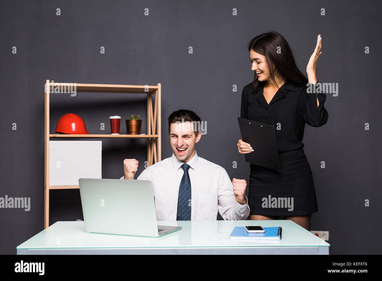 Young office workers in front of desktop computer Stock Photo - Alamy