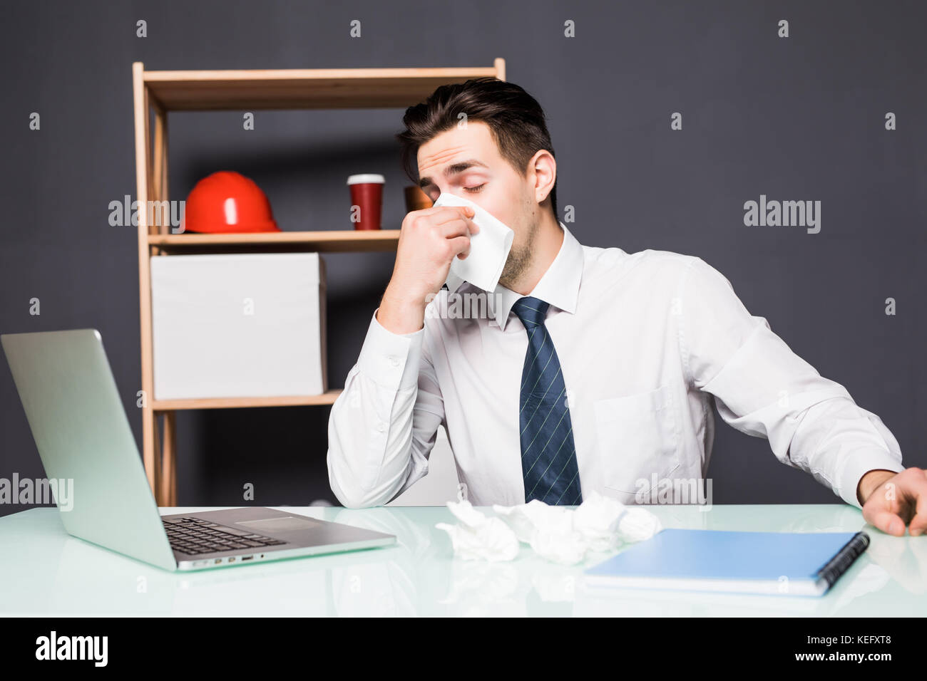 businessman having cold in the head and sitting at workplace Stock ...
