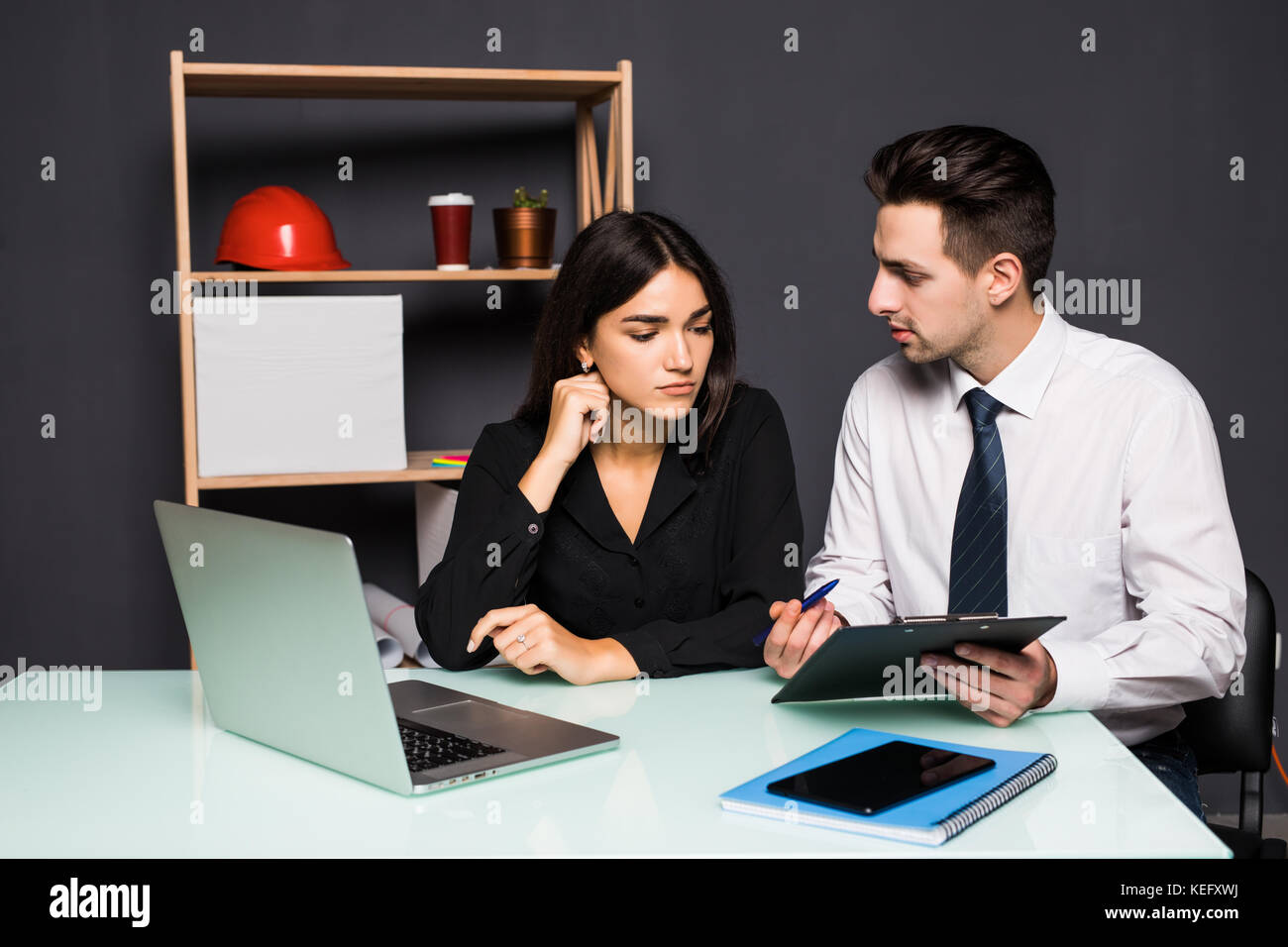 Team work process. Two partners with laptop in open space office ...