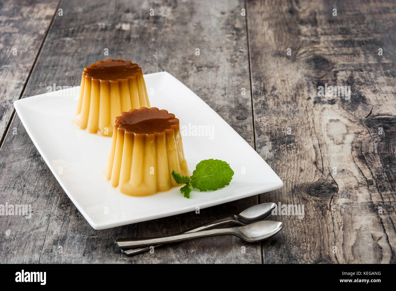 Creme caramel. Egg pudding on wooden table Stock Photo - Alamy