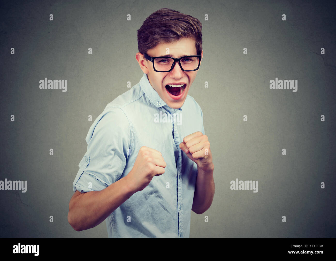 young man in rage threatening to punch someone with fists Stock Photo ...