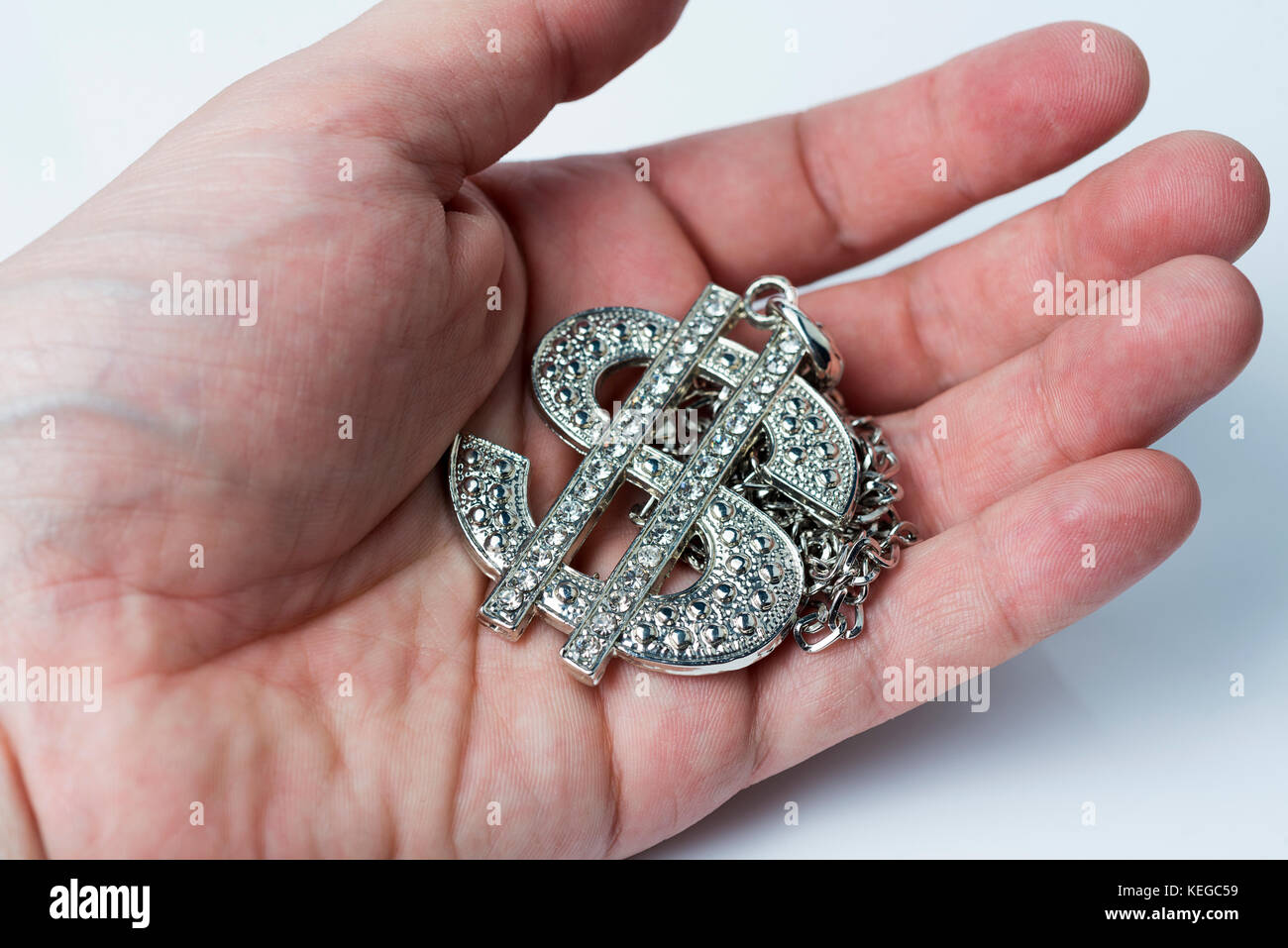 Hand holding dollar sign on a white background Stock Photo - Alamy