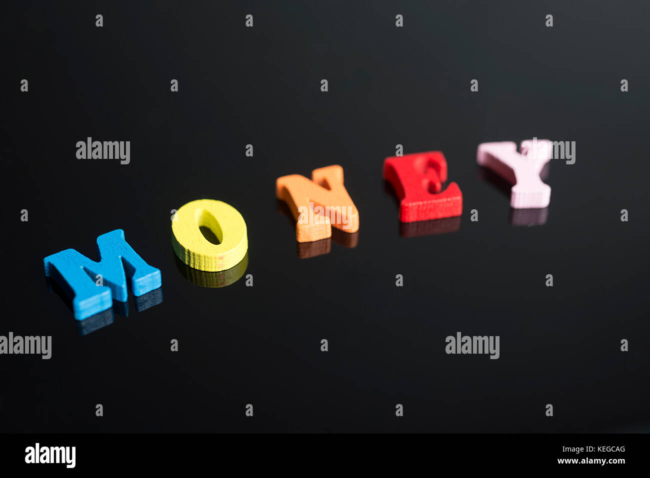 The word money out of colorful letters on a black background Stock ...