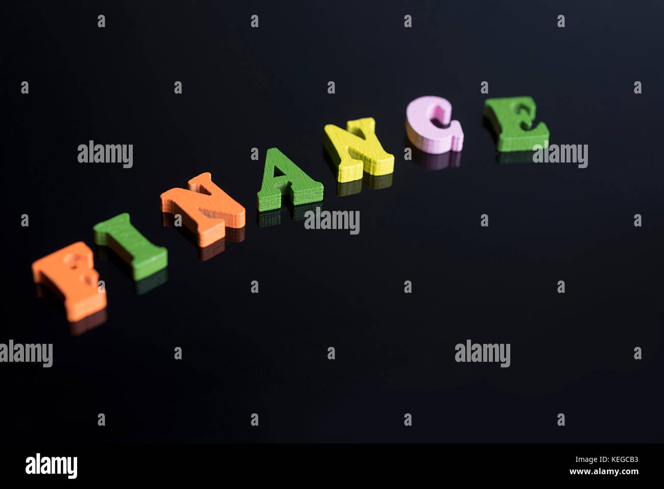The word Finance of colored letters on black background Stock Photo - Alamy