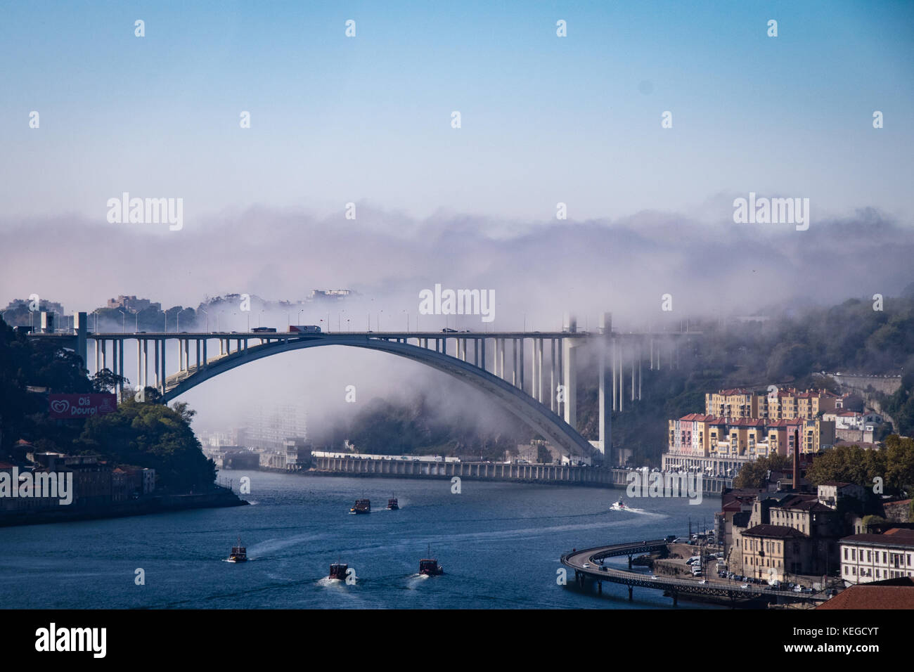 Sea mist fog under the Arrabida Bridge over the River Douro, Porto ...