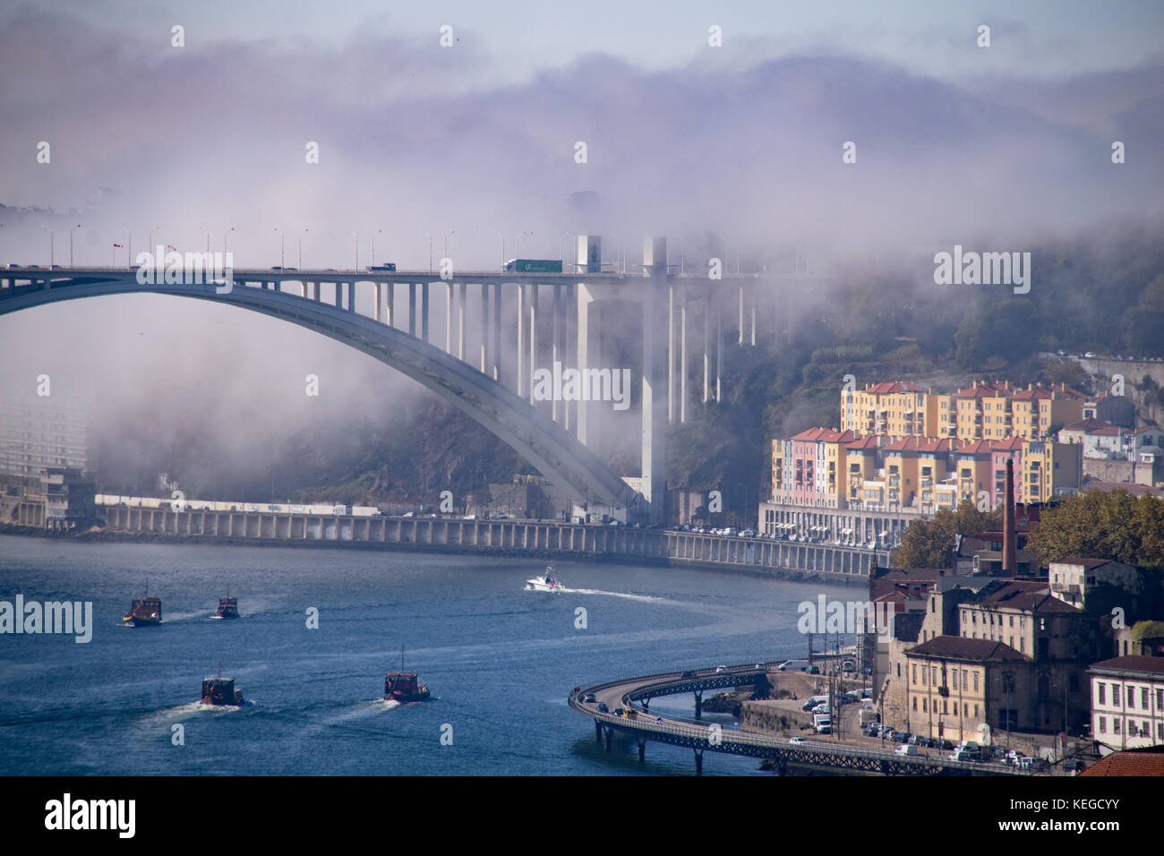Sea mist fog under the Arrabida Bridge over the River Douro, Porto ...