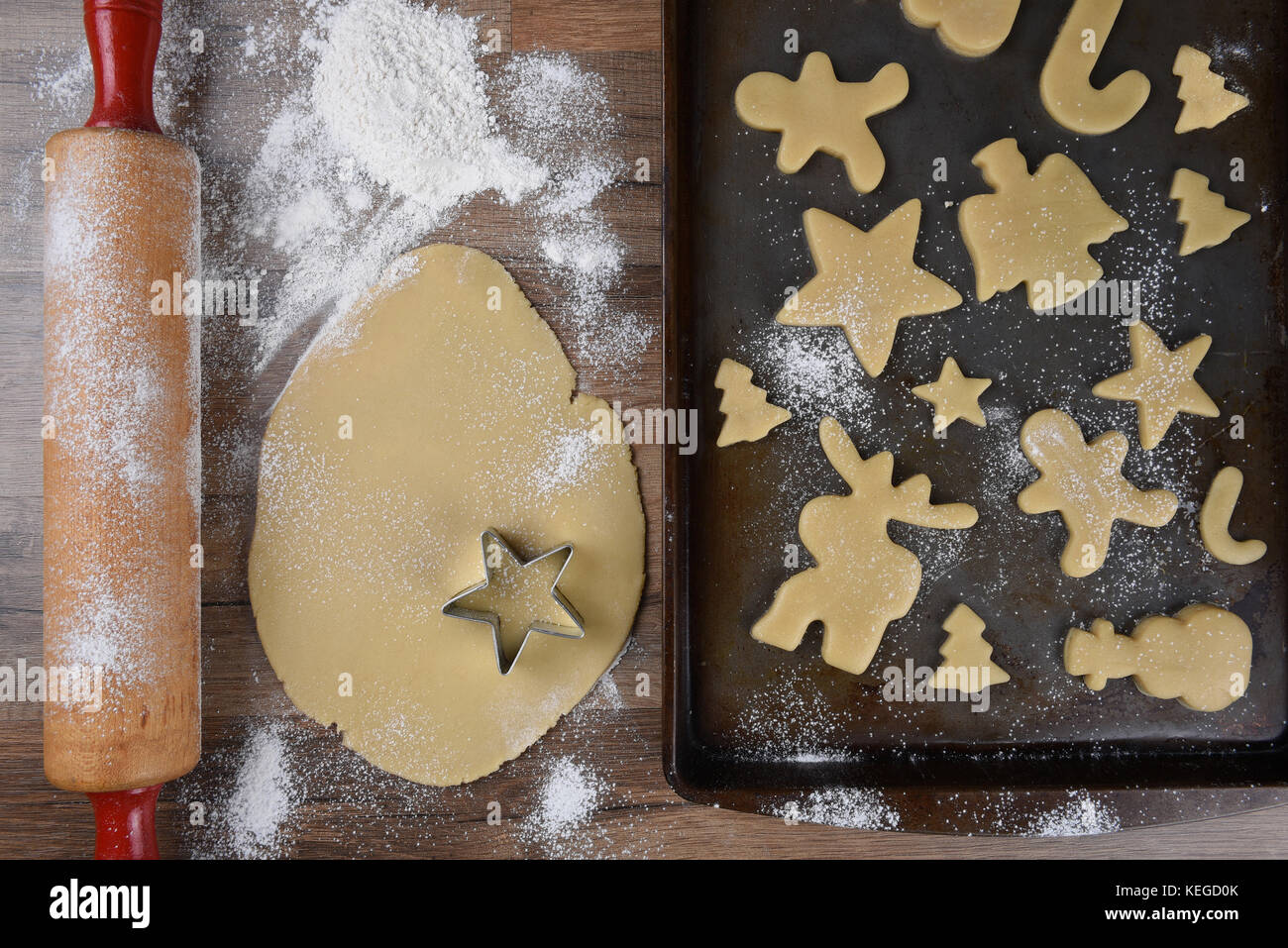 Top view of a baking sheet with a holiday shaped sugar cookies, with ...