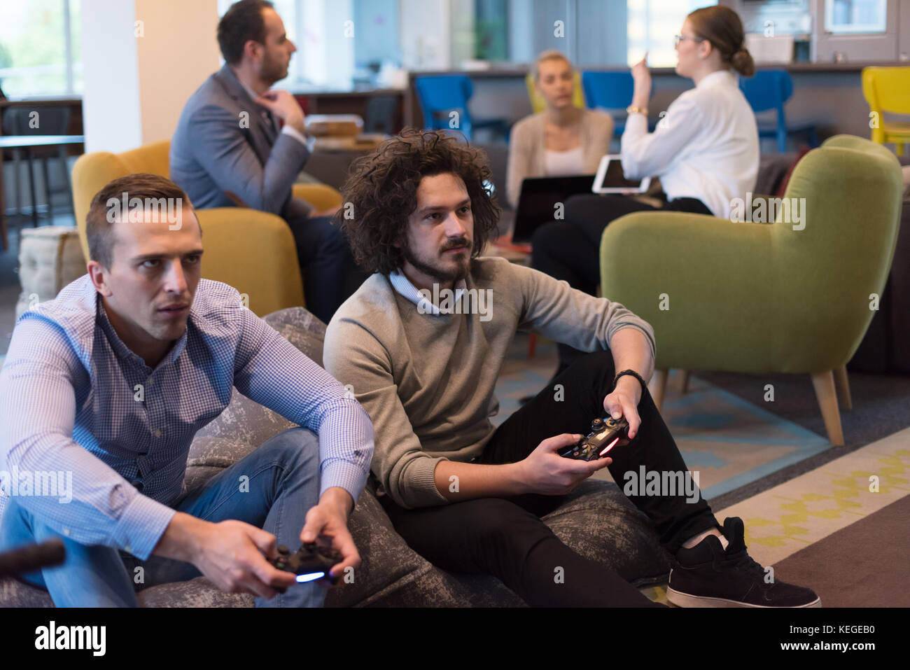 Work hard play hard. Workers Playing computer games in creative startup ...