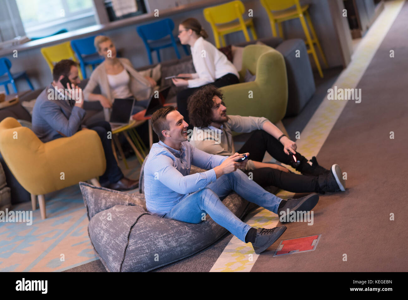 Work hard play hard. Workers Playing computer games in creative startup ...