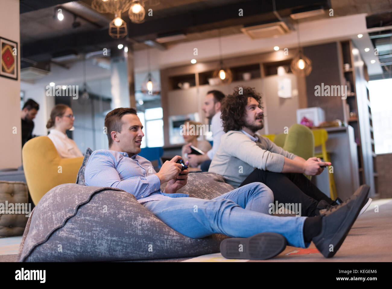 Work hard play hard. Workers Playing computer games in creative startup ...