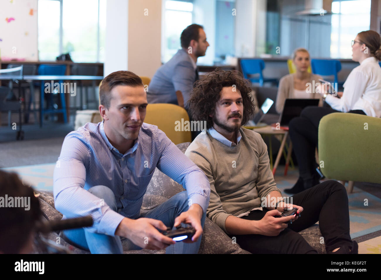 Work hard play hard. Workers Playing computer games in creative startup ...