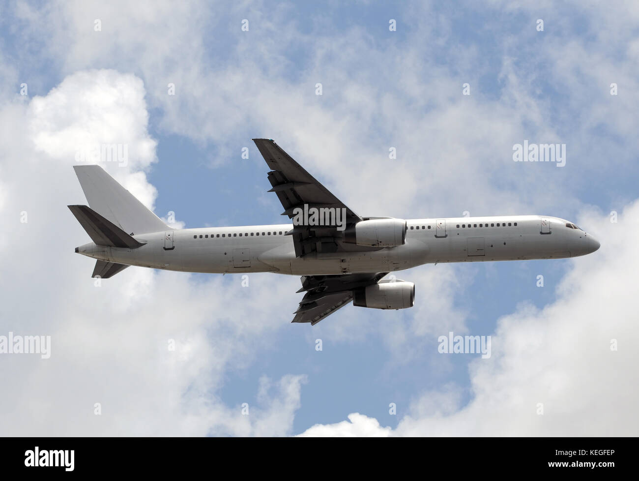 Unmarked white jet airplane in leveled flight Stock Photo - Alamy