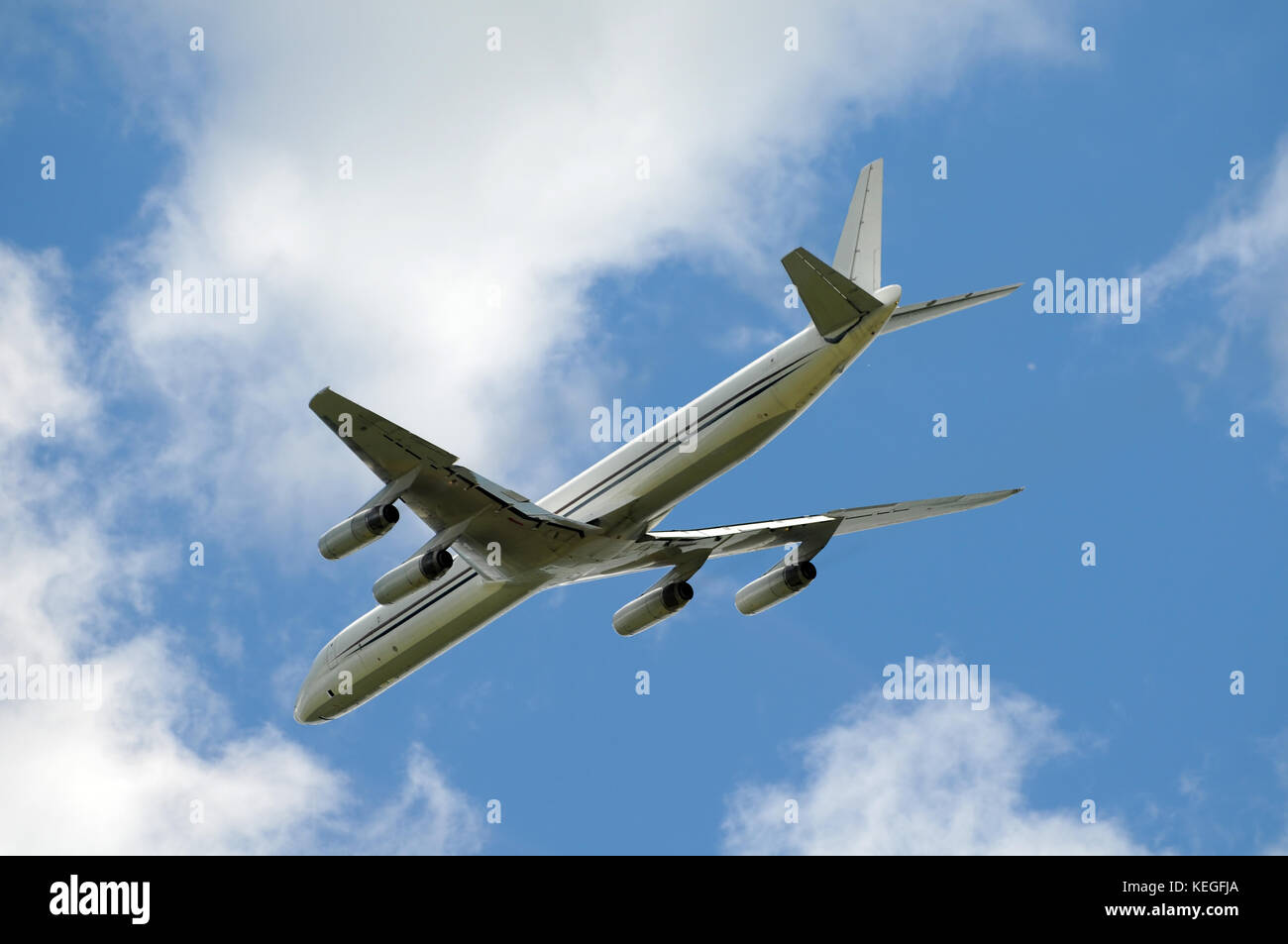 Quad engine jet airplane with landing gear up Stock Photo - Alamy
