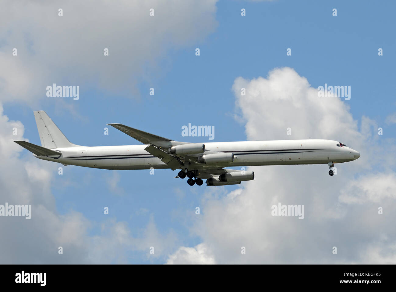 Unmarked cargo jet airplane landing side view Stock Photo - Alamy