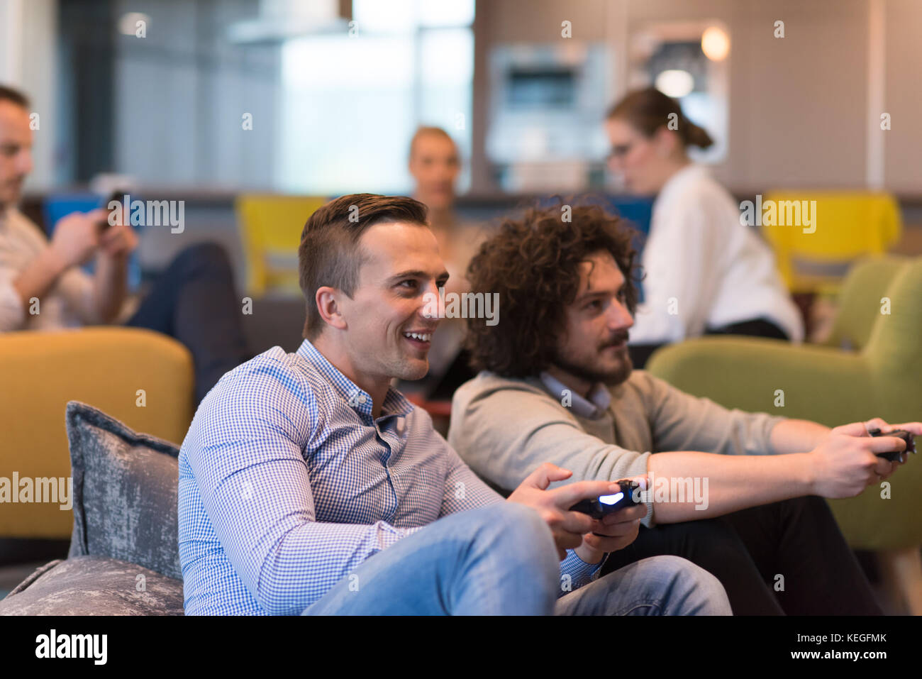 Work hard play hard. Workers Playing computer games in creative startup ...